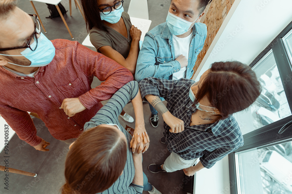 Students greeting each other with their elbows Stock Photo | Adobe Stock
