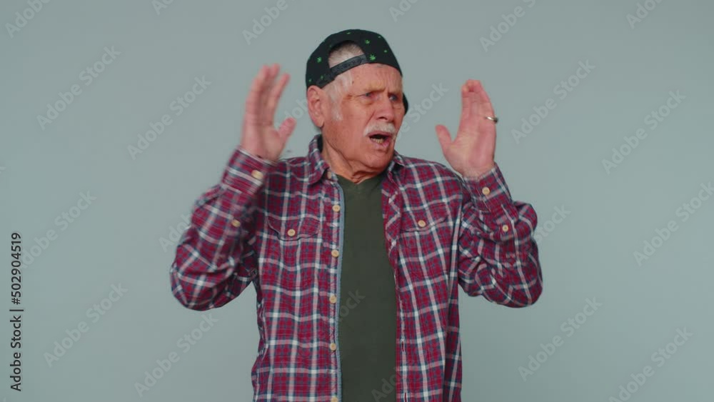 Elderly mature man scared fearful, covering ears with hands, closing ...
