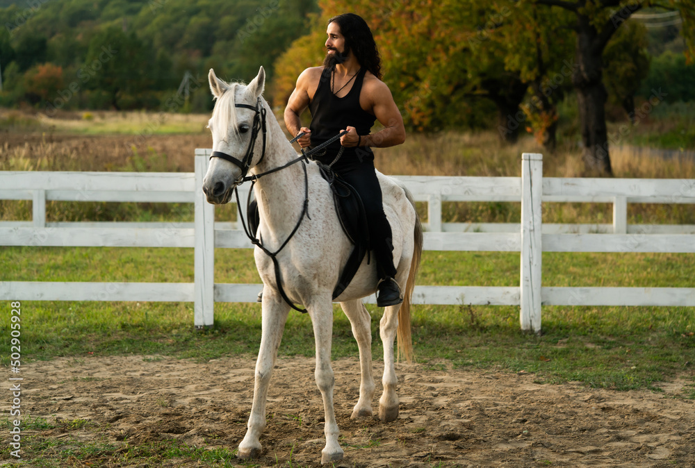 Handsome muscular man riding horse. Hunky cowboy. Young muscular guy in ...