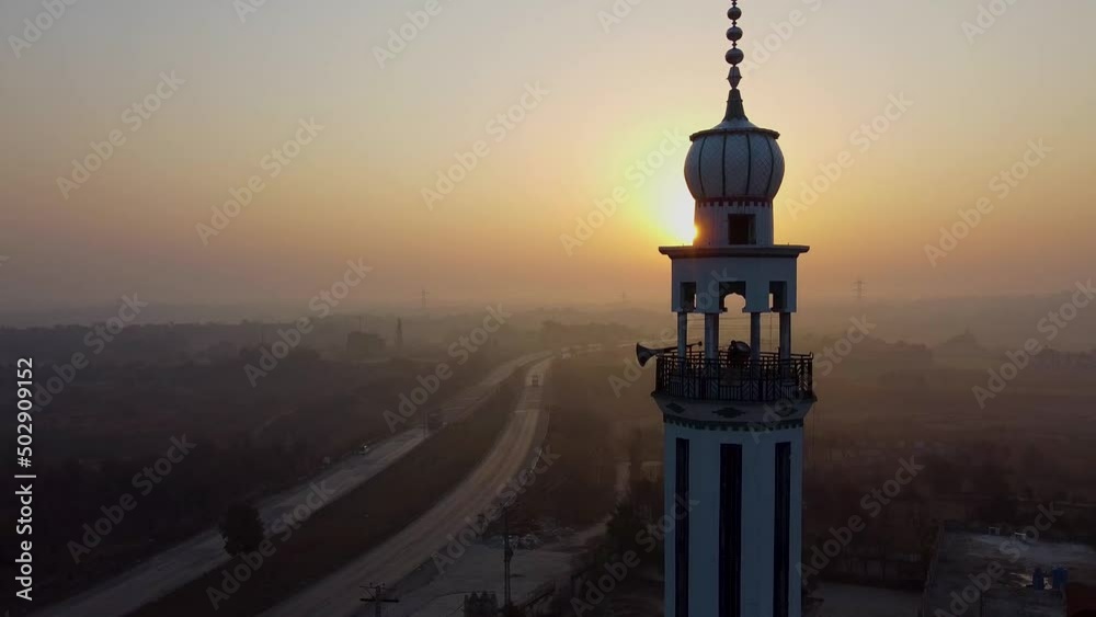 Sunrise sunset of road with traffic with minaret of Masjid in Pakistan ...