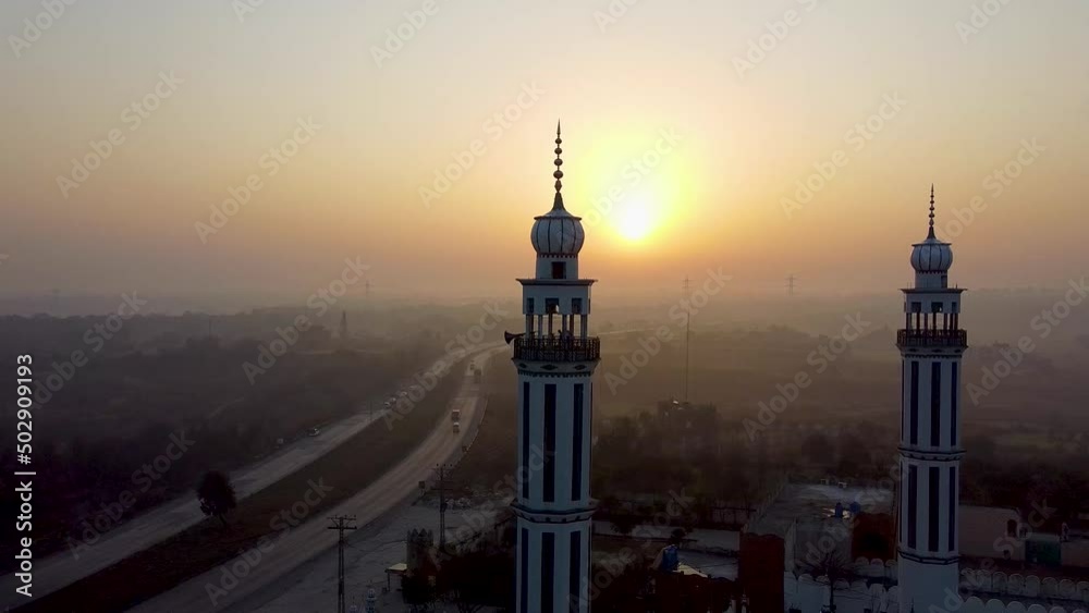 Sunrise sunset of road with traffic with minaret of Masjid in Pakistan ...