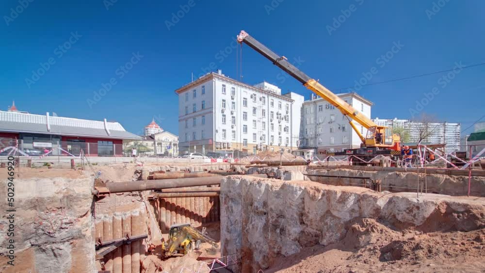 A large huge ditch pit tunnel timelapse with crane and excavator ...