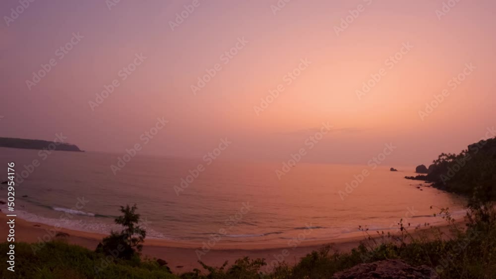 4K Wide angle time lapse of sun setting behind the sea as seen from ...