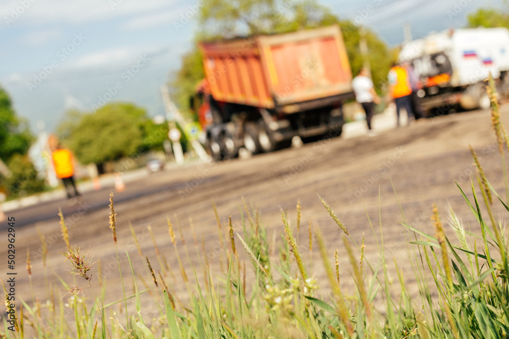 Blur background of construction site is laying new asphalt road ...