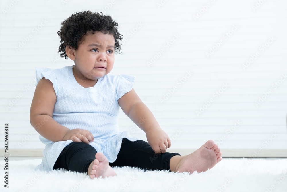 Little pitiful African American chubby kid girl is crying with tears ...