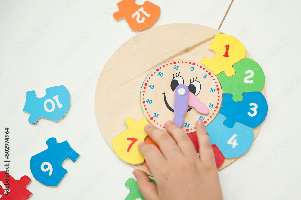 Boy learning time with wooden clock. Toy for Learning method for ...