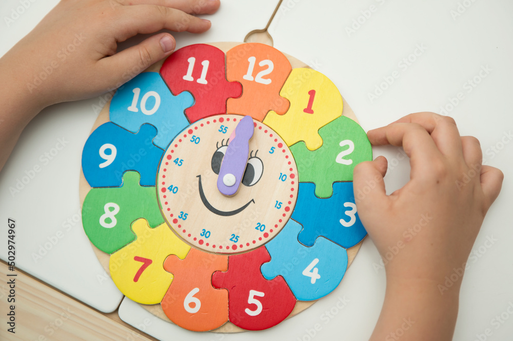 Boy learning time with wooden clock. Toy for Learning method for ...