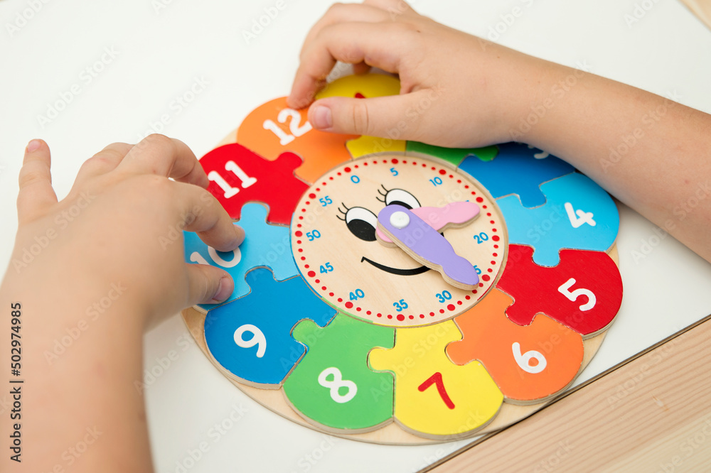 Boy learning time with wooden clock. Toy for Learning method for ...