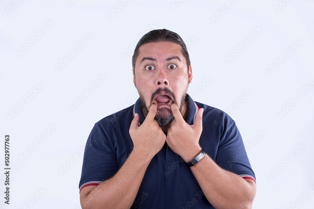 A foolish man taunting by pulling his mouth down his his finger and ...