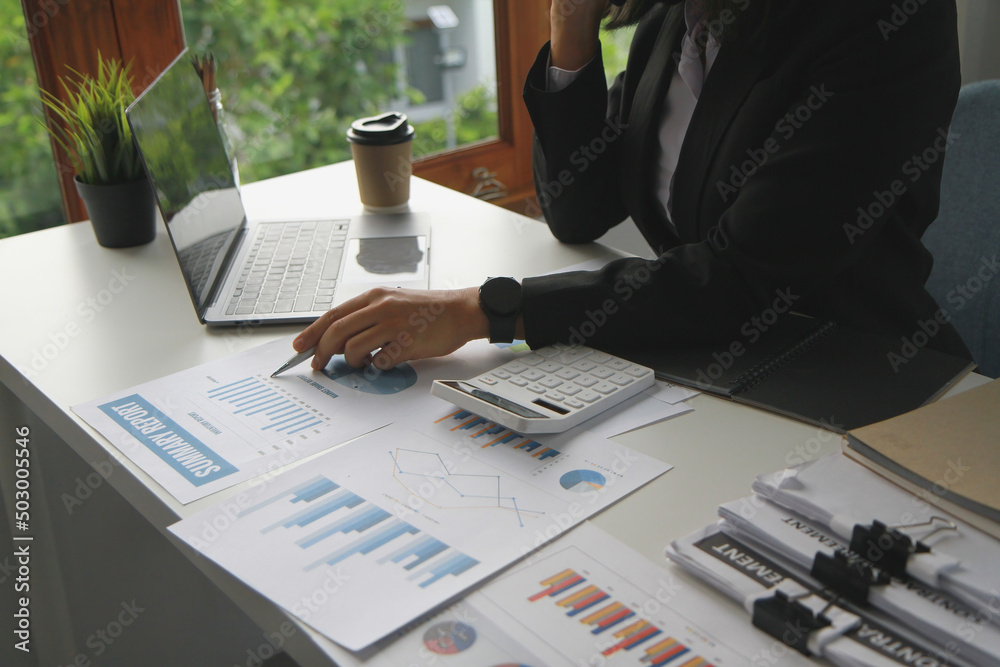 Financial advisor calculating numbers datasheets graphs charts reports ...