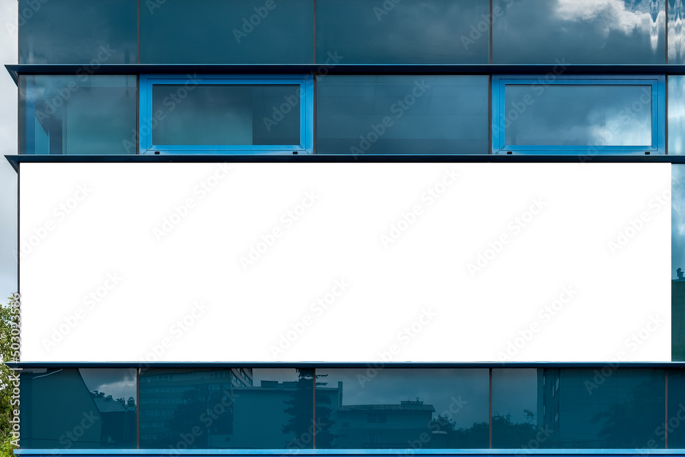 Blank white advertising banner on the wall of modern building with ...
