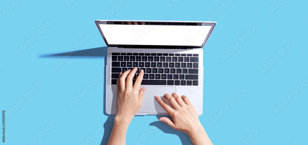 Person using a laptop computer from above Stock Photo | Adobe Stock