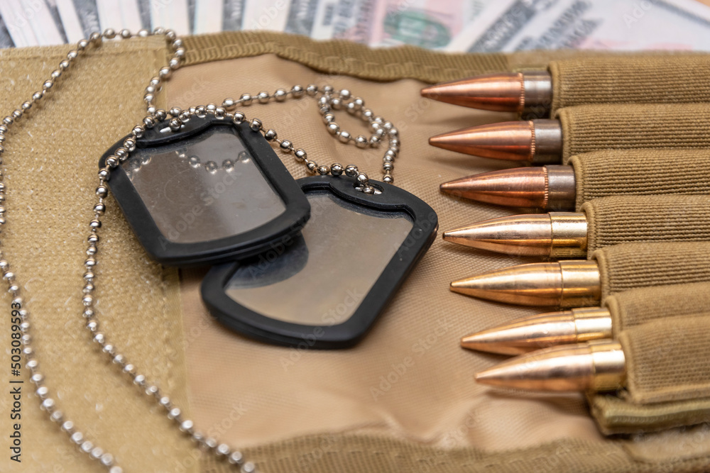 Army identification medallions on American dollar bills, bandolier with ...