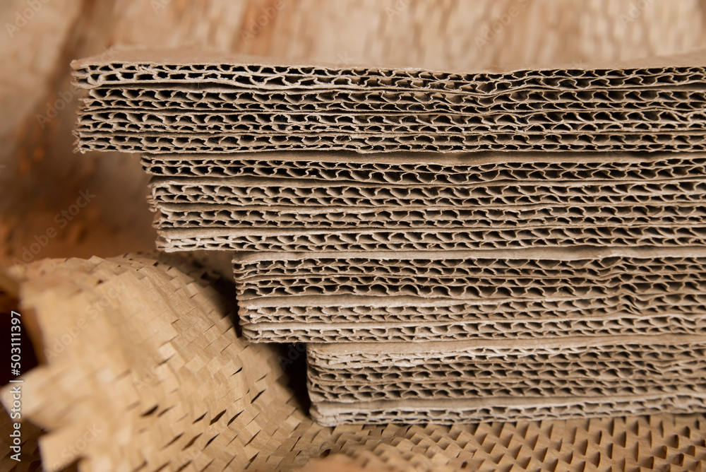 Sheets of corrugated cardboard lie on top of each other on kraft paper ...
