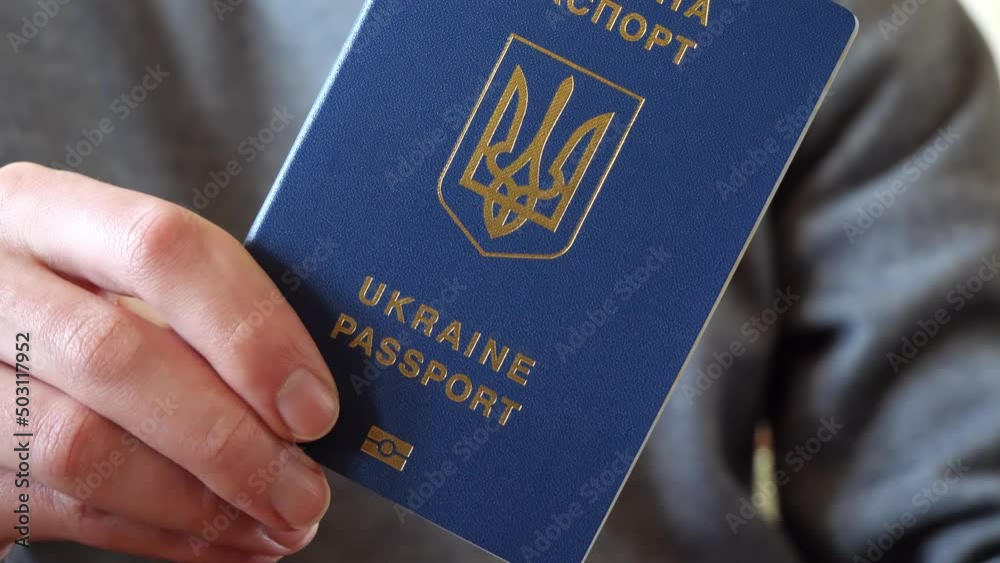 Ukrainian Biometric Passport In The Hand Of Its Owner In Close Up