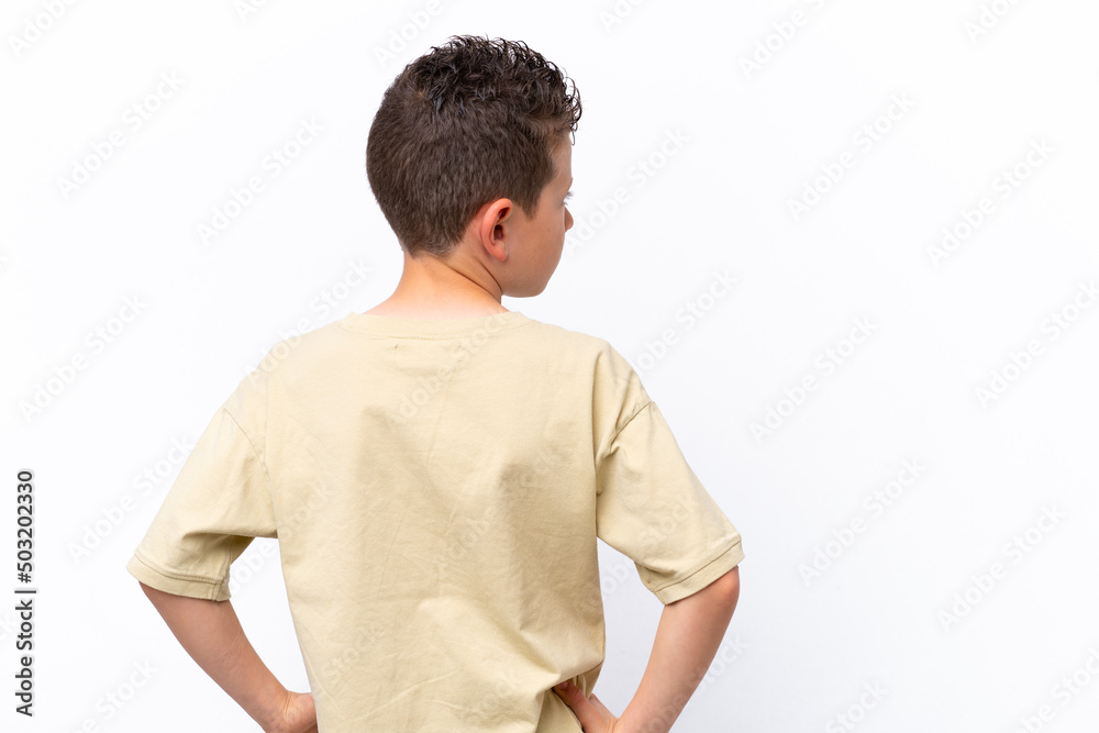 Little caucasian boy isolated on white background in back position and ...