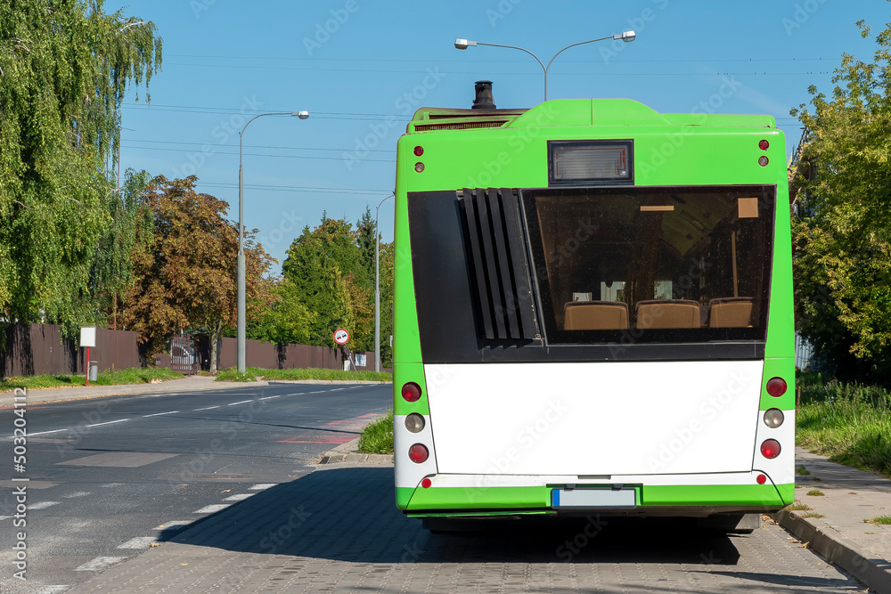 Modern green and white bus with blank white space for advertisement ...