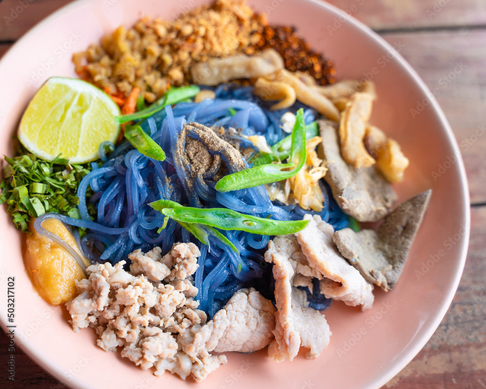 Tom Yum Pork Noodles with the purple color of noodles applied ...