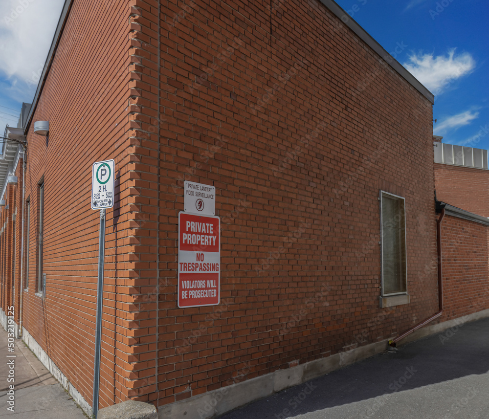 Outside corner of a one storey red brick office building with sharp ...