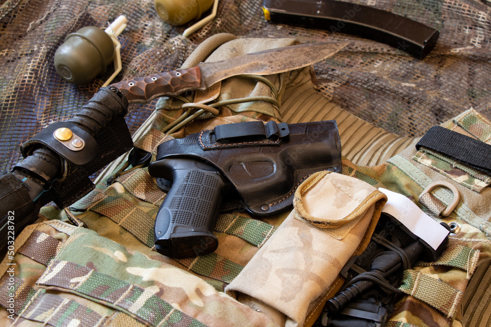 Military reinforced bulletproof vest and pistol, weapon, uniform of a ...