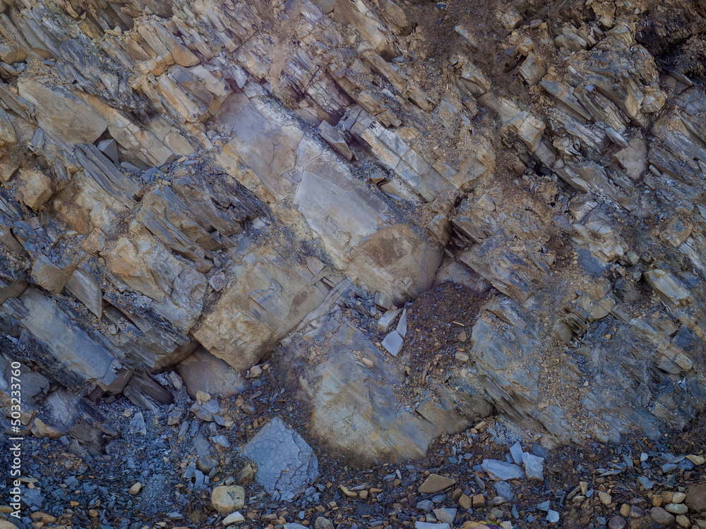 Texture of layers and cracks in sedimentary rock on cliff face. Cliff ...