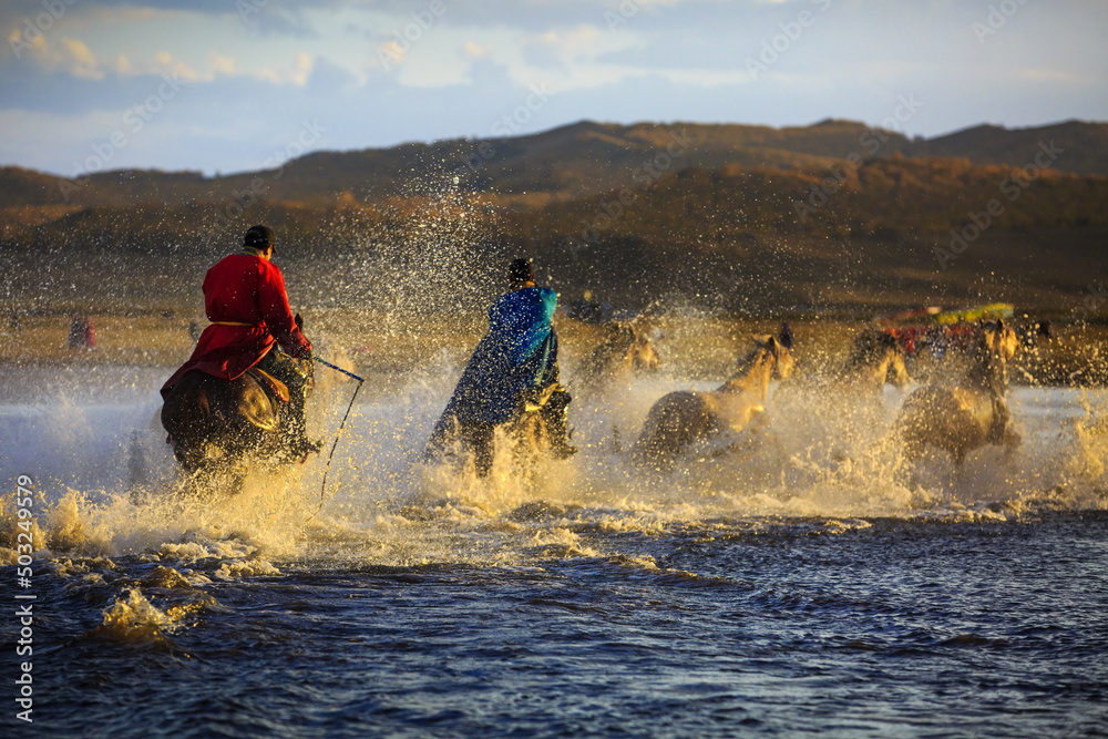 The horse herder rode his horse across the river and stepped out of the ...
