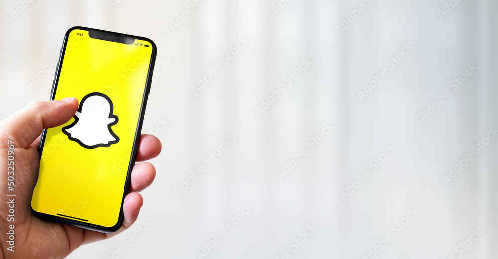 Hand holding iphone smartphone with Snapchat logo, Paris, France Stock ...