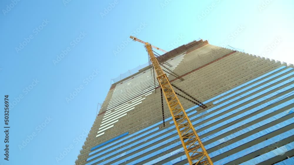 Large construction crane and building against sky. Tower crane on ...