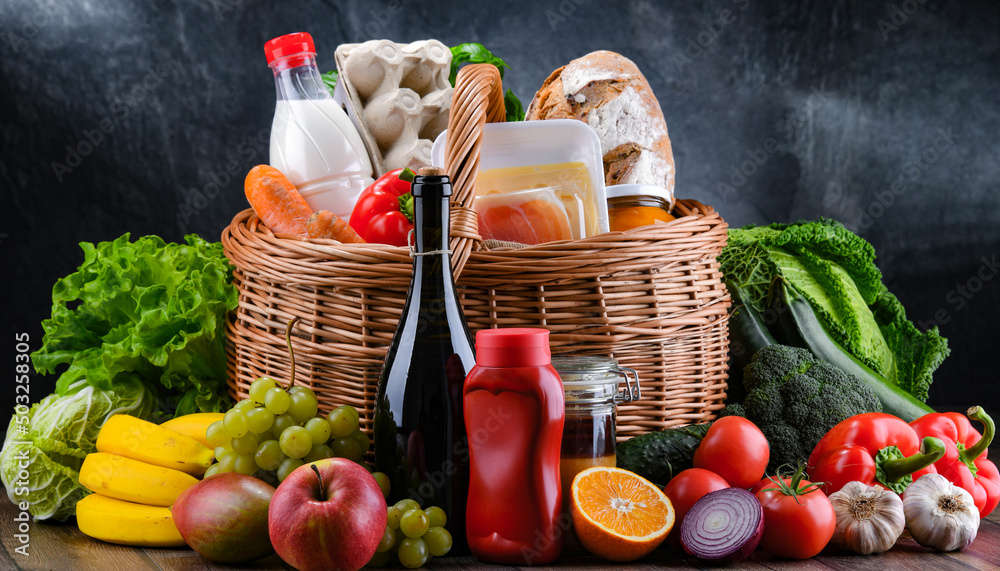 Wicker basket with assorted grocery products Stock Photo | Adobe Stock