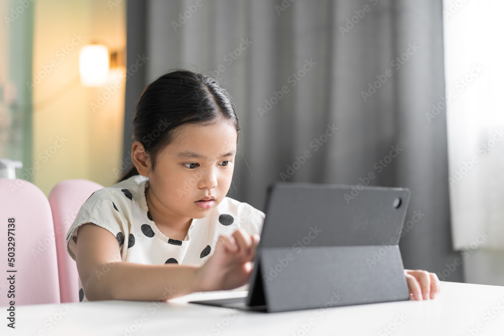 asian child learning and read with finger touch screen on computer ...