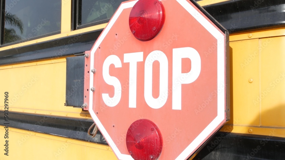 Red stop sign, yellow school bus in California, USA. Traffic warning on ...