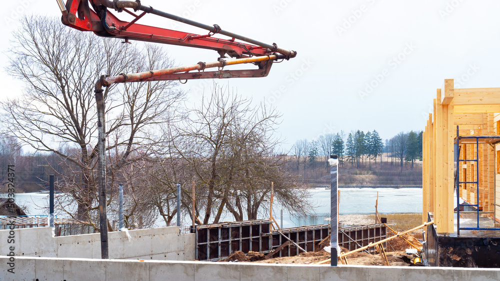 A boom pump uses a remote-controlled robotic arm attached to a truck to ...