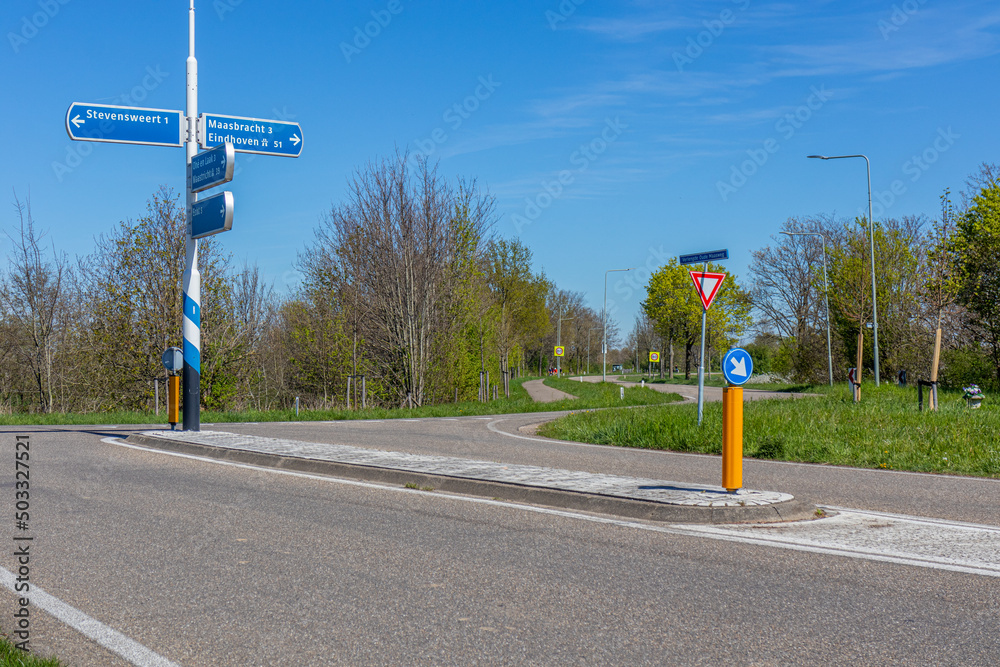 Rural road intersection, signs indicating the direction to Stevensweert ...