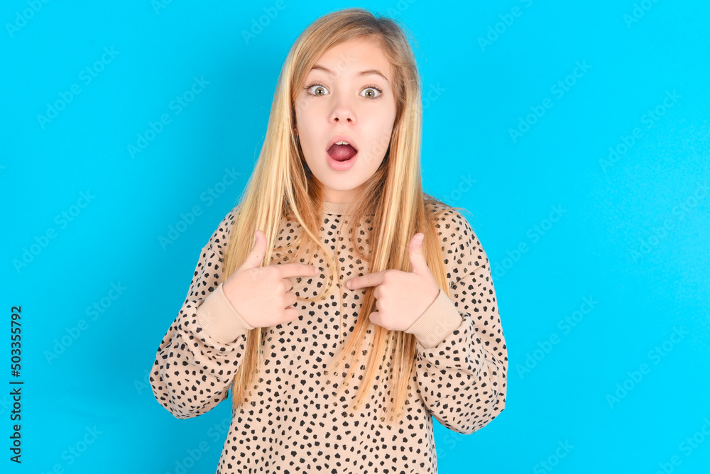 Embarrassed little caucasian kid girl wearing animal print sweater ...