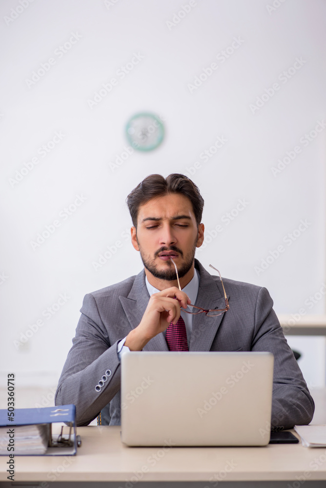 Young male employee working in the office Stock Photo | Adobe Stock