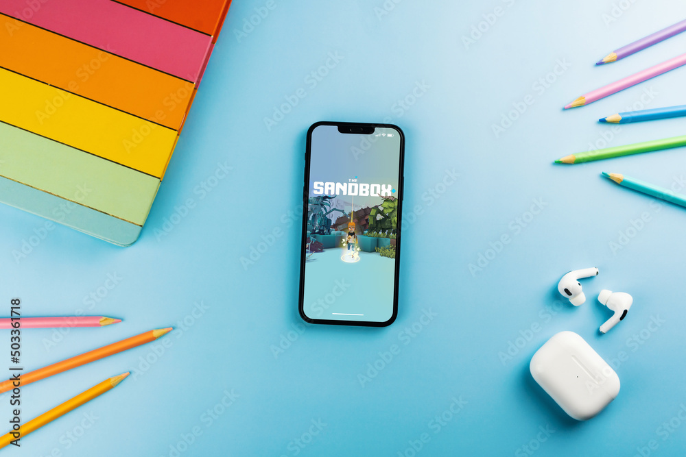 The Sandbox mobile game (Metaverse) app on the smartphone screen. Blue ...