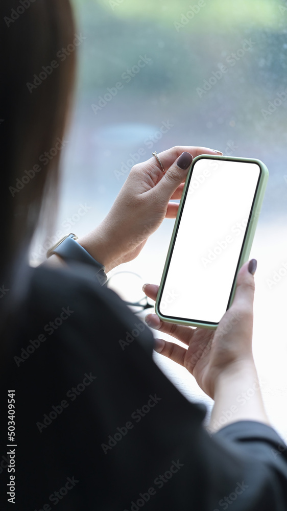 Back view young woman holing mobile phone with white screen for ...