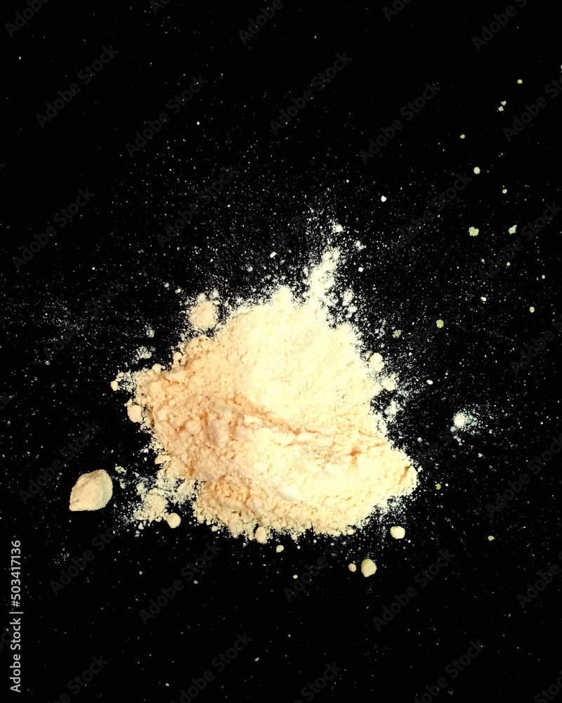 White powder explosion isolated on Dark background. White dust ...