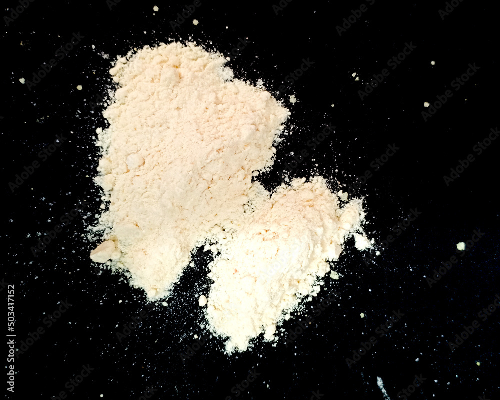 White powder explosion isolated on Dark background. White dust ...