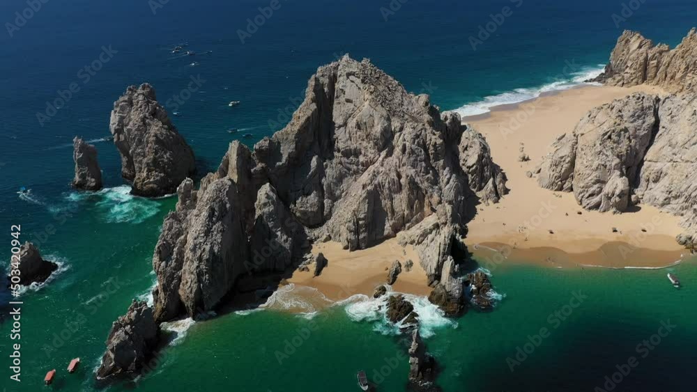 Cinematic drone shot of sea cliffs with Playa del Amor and El Arco in ...