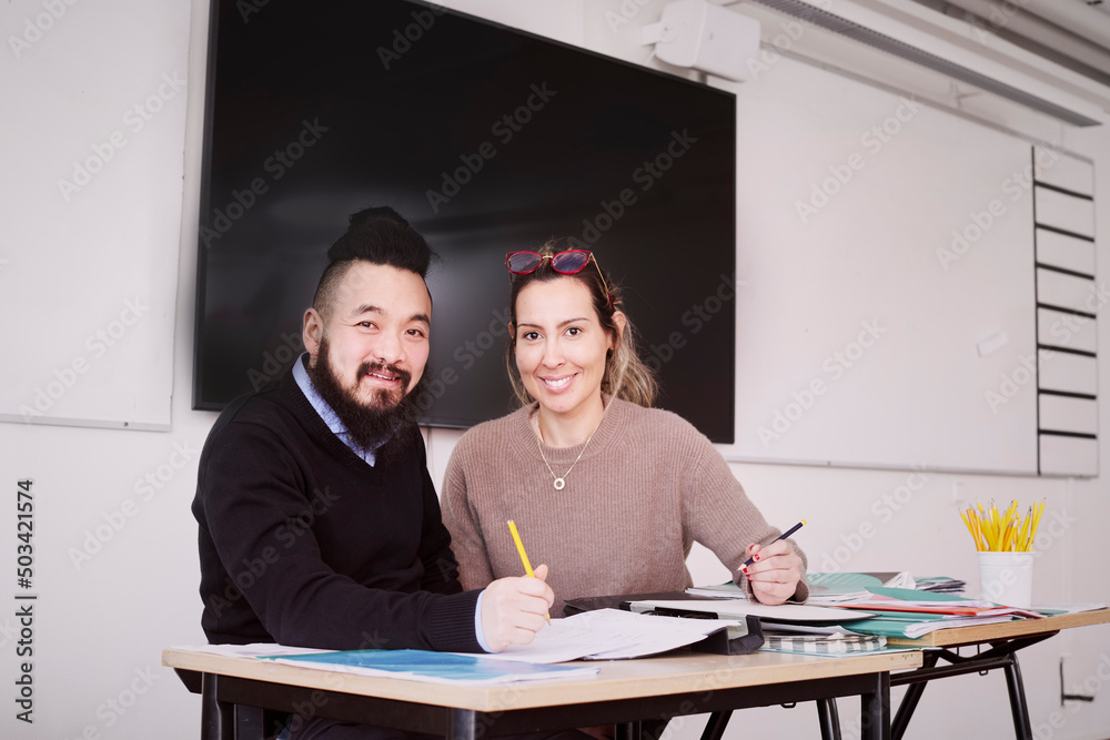 Smiling teachers in classroom Stock Photo | Adobe Stock