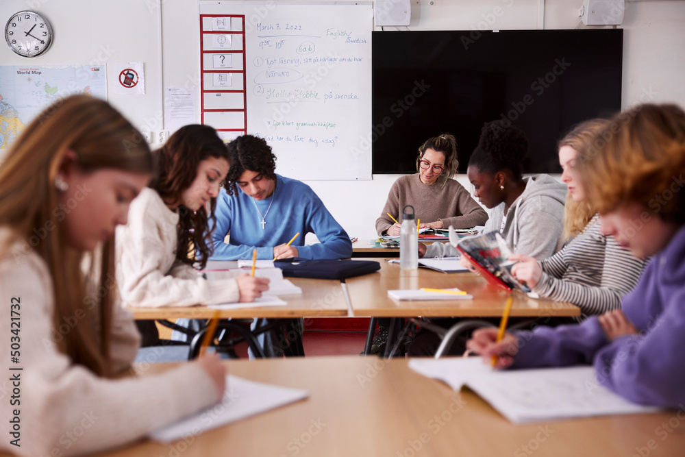 Teenagers in classroom Stock Photo | Adobe Stock