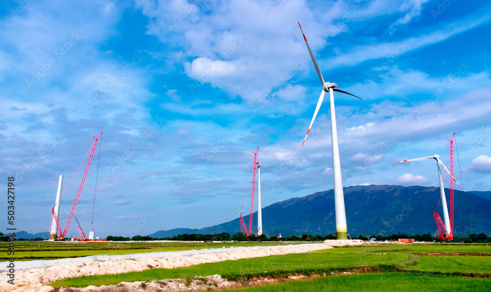 Construction of Wind Turbine Tower using Big red crane under beautiful ...