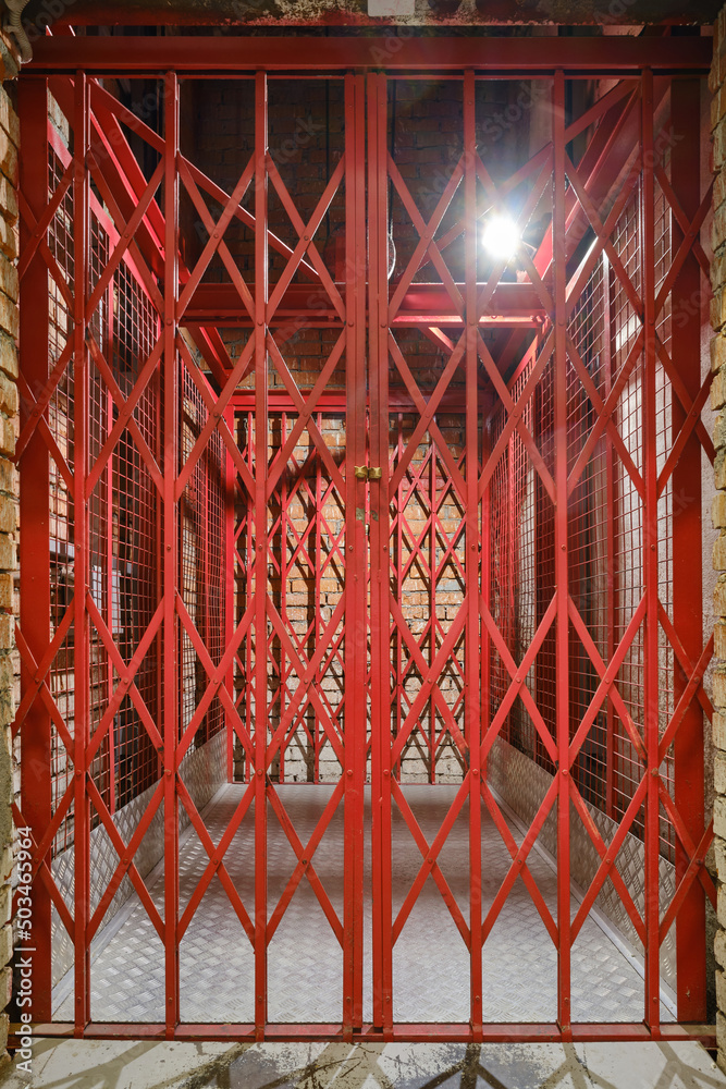 Red latticed freight elevator doors. Factory elevator gate. Self ...