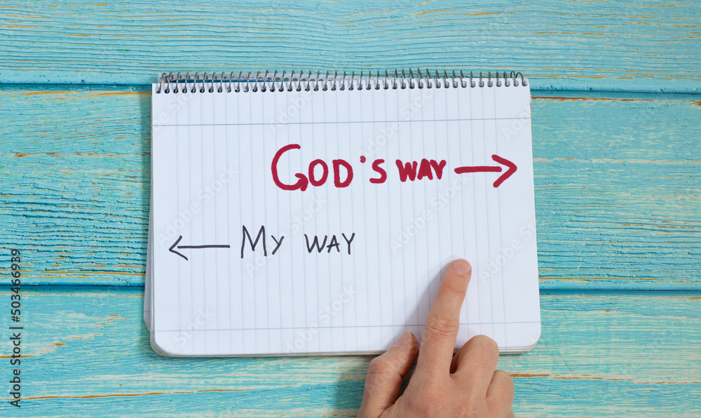 God's way, message quote on a notebook with a hand showing in direction ...