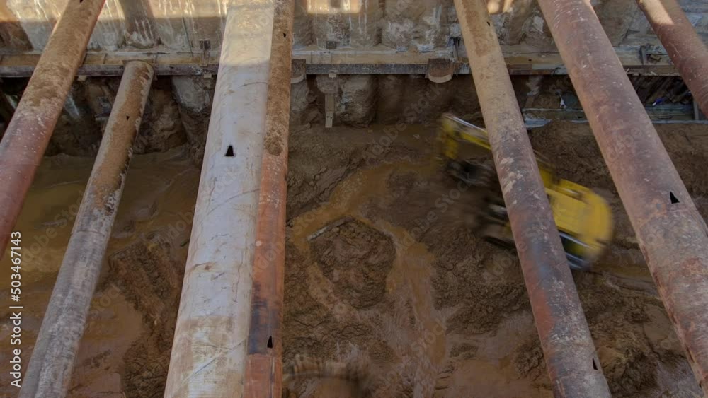 Excavators inside huge ditch pit at the construction site of the ...