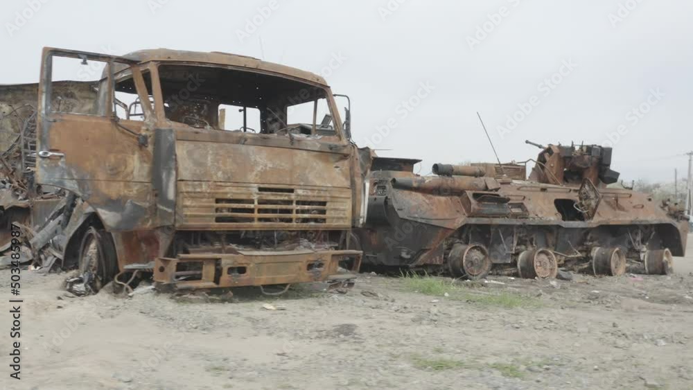 Destroyed military convoy. Burnt combat vehicles. Rusty tech ...
