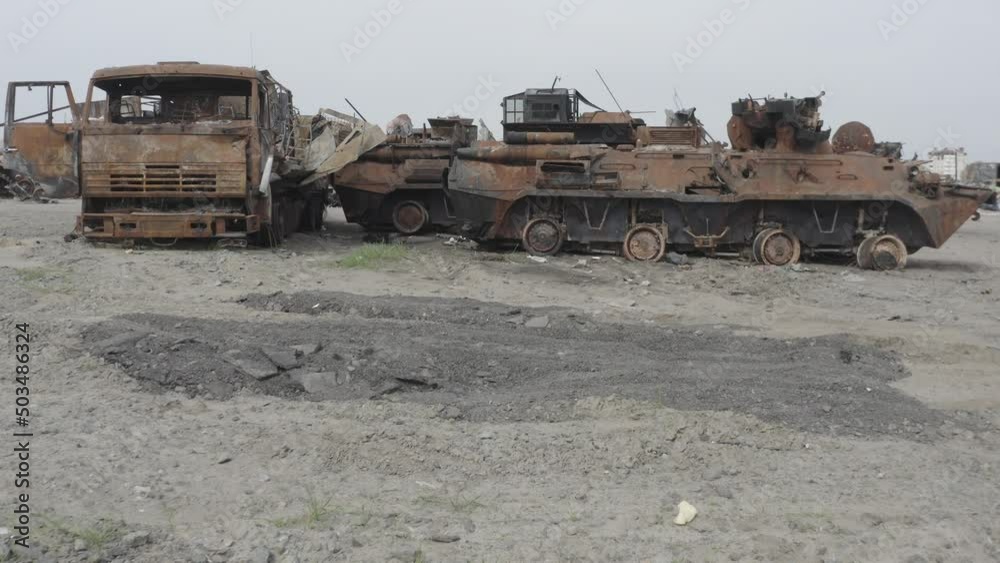 Destroyed military convoy. Burnt combat vehicles. Rusty tech ...