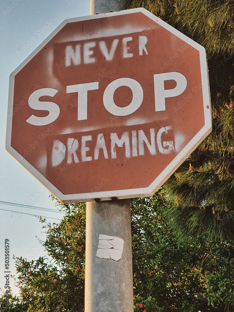 Traffic sign of stop with the message never stop dreaming Stock Photo ...