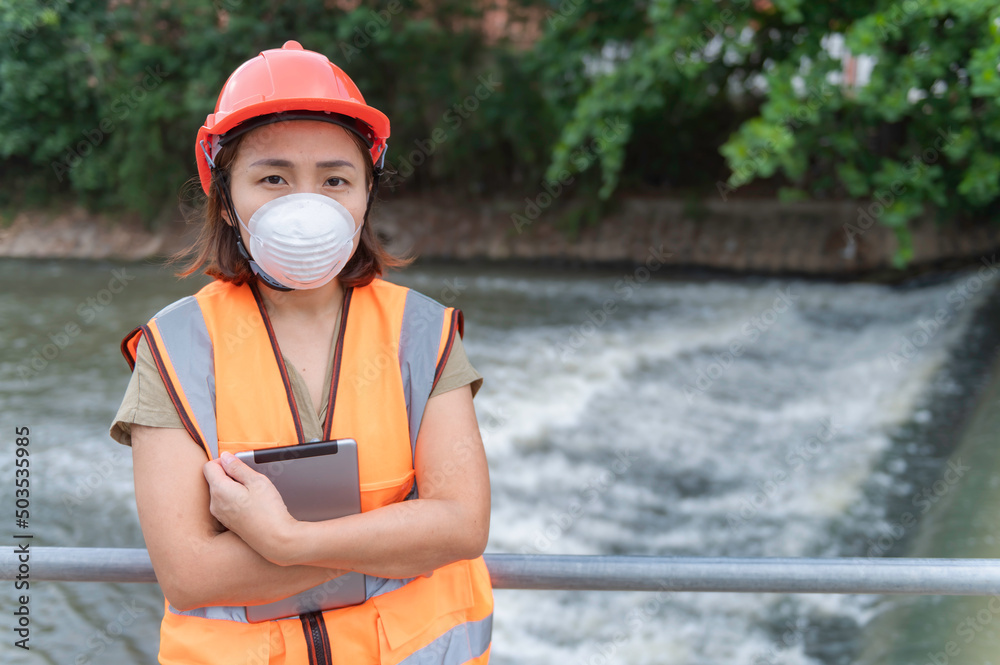 Foto de Asian Female engineering working . at sewage treatment plant ...